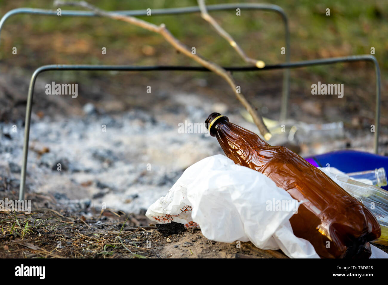 A pile of garbage in the forest park near the campfire site ...