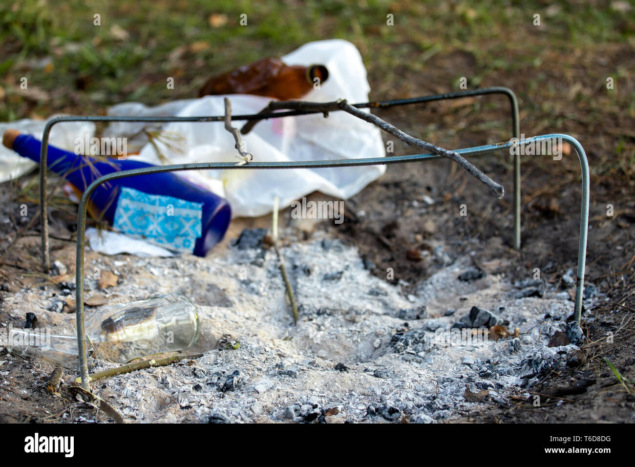 A pile of garbage in the forest park near the campfire site ...