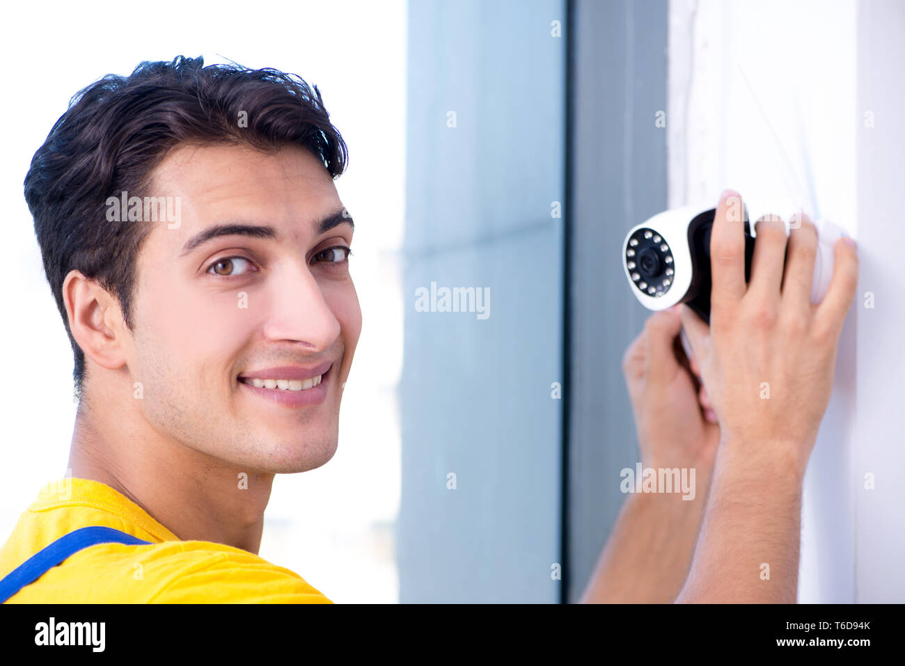Contractor installing surveillance CCTV cameras in office Stock Photo ...