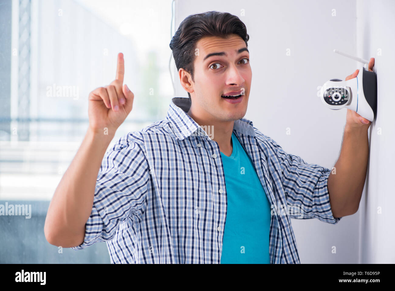 Man installing surveillance CCTV cameras at home Stock Photo - Alamy