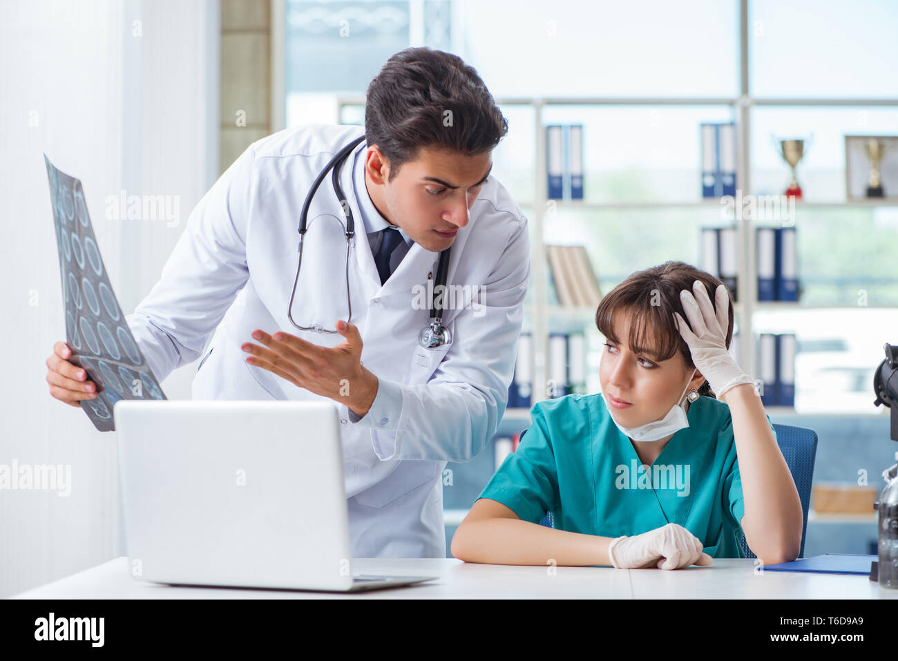 Two doctors discussing x-ray MRI image in hospital Stock Photo - Alamy