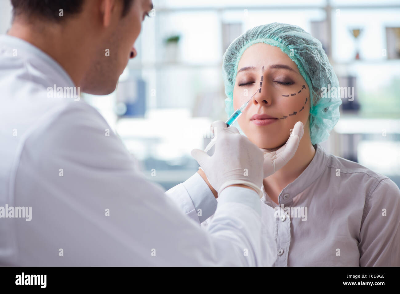 Plastic surgeon preparing for operation on woman face Stock Photo - Alamy