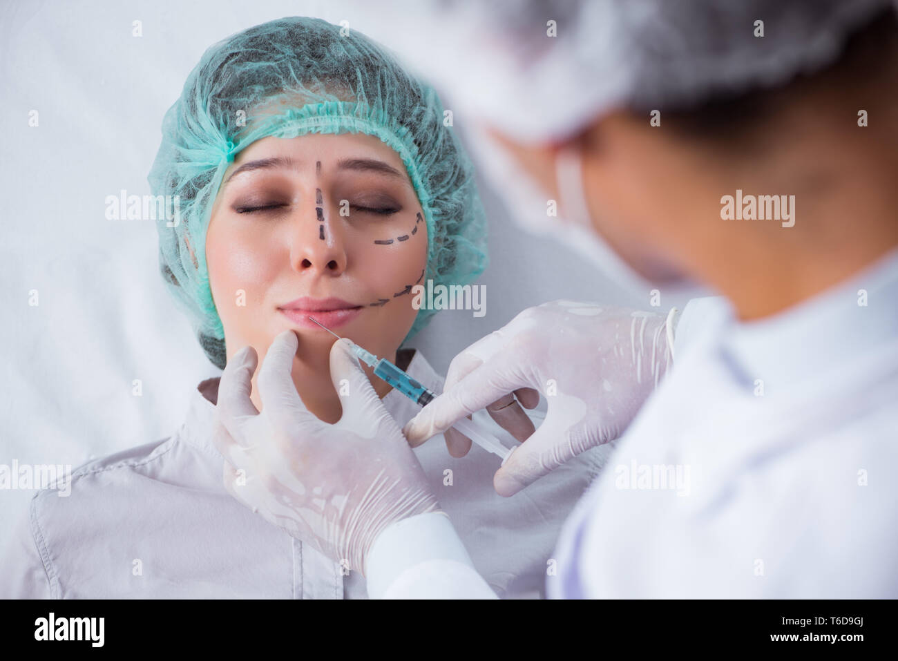 Plastic surgeon preparing for operation on woman face Stock Photo - Alamy