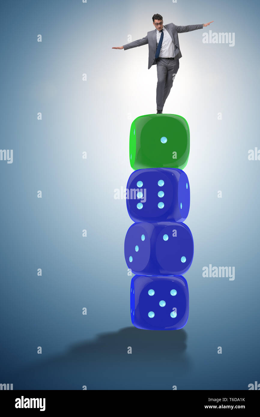 Businessman balancing on top of dice stack in uncertainty concep Stock ...
