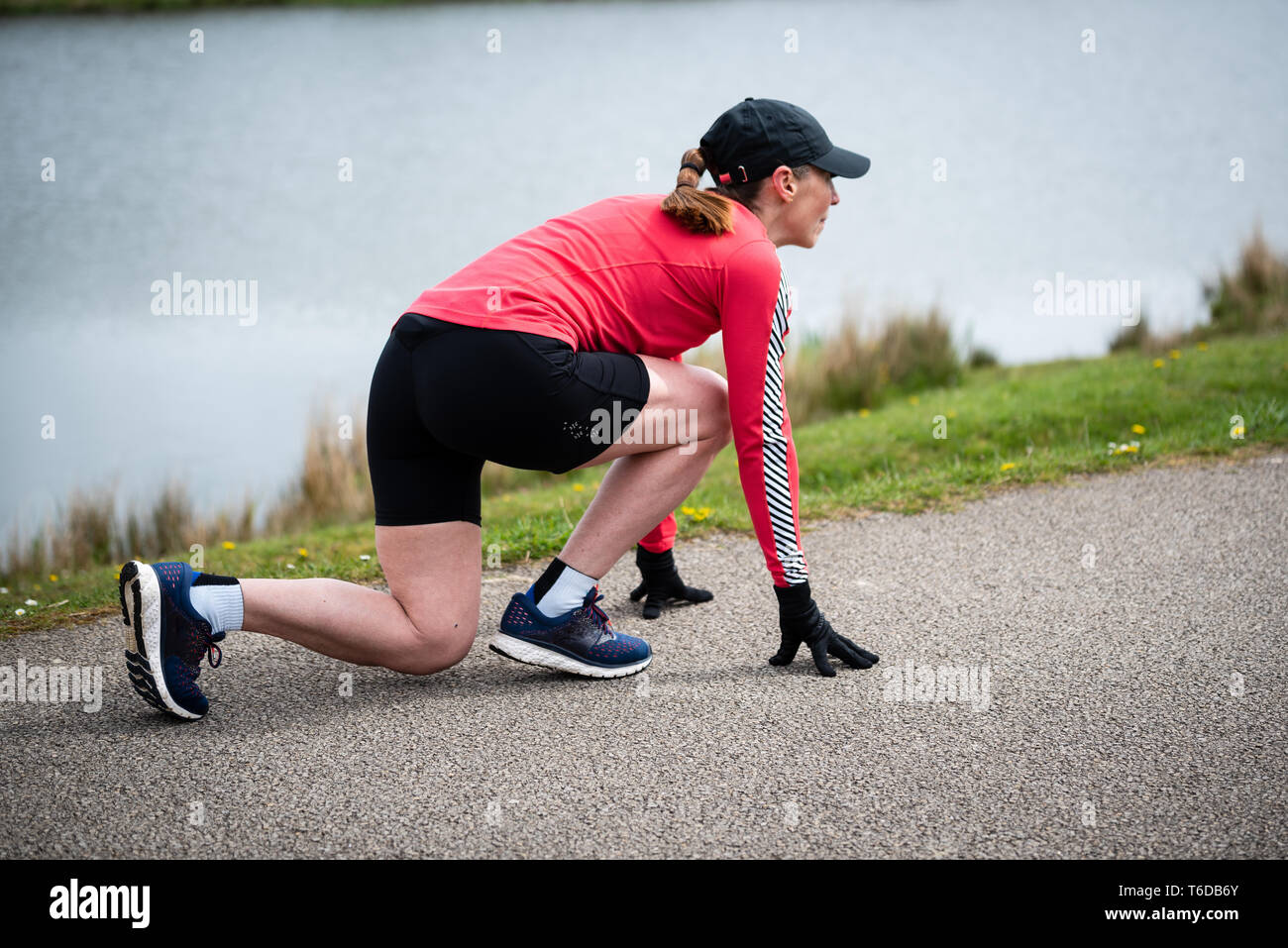 Fit senior woman in 50s getting ready to run in a park Stock Photo - Alamy
