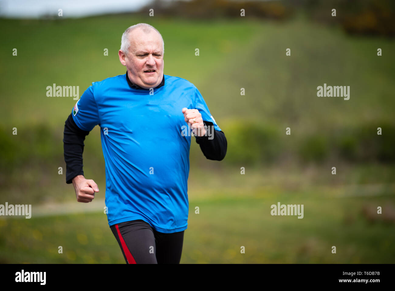 Senior man in 60s exercising and keeping fit by running in a park Stock ...