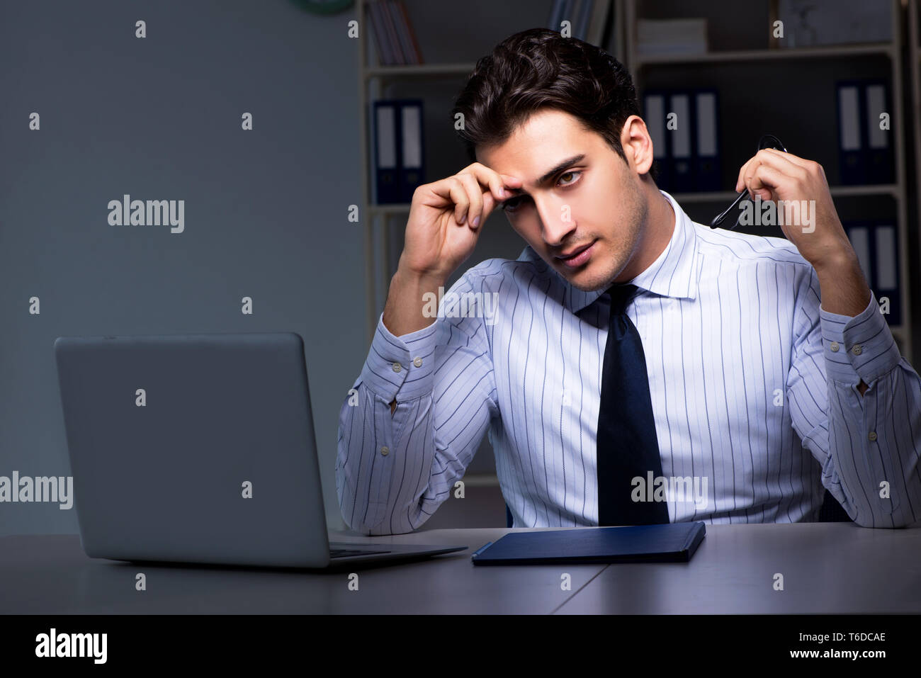 Tired and exhausted helpdesk operator during night shift Stock Photo ...