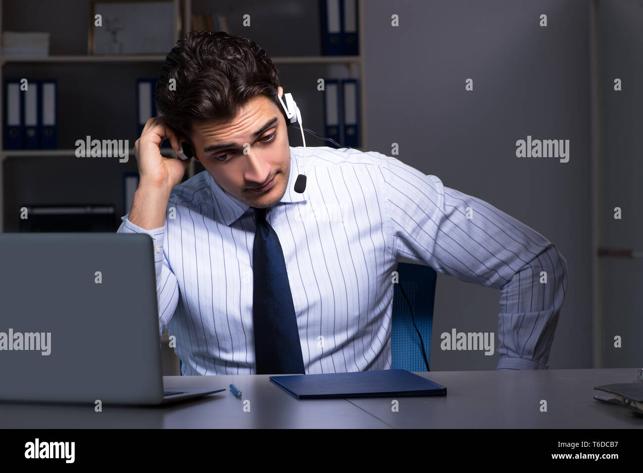 Tired and exhausted helpdesk operator during night shift Stock Photo ...