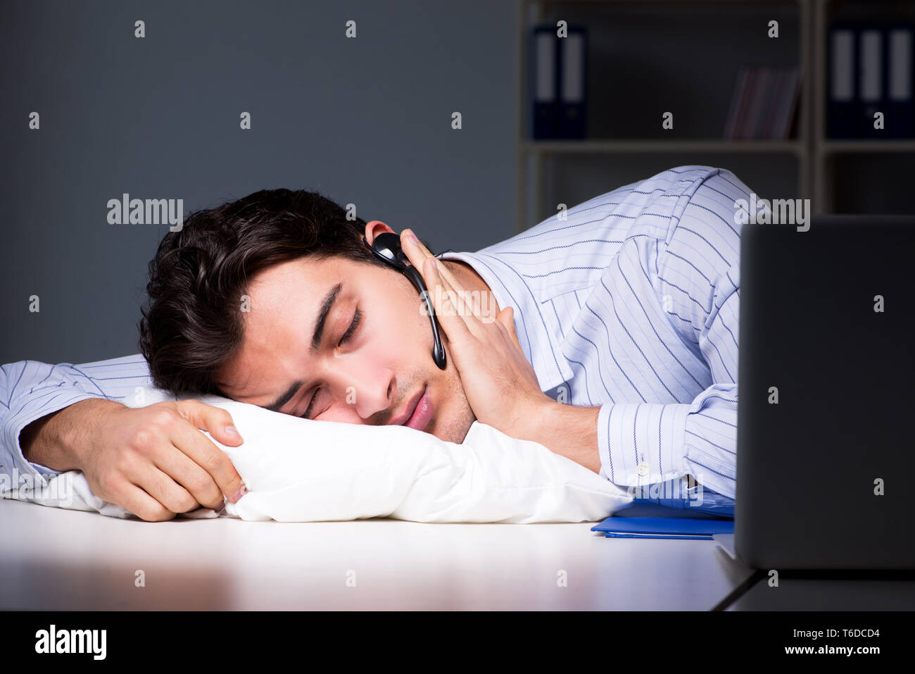 Tired and exhausted helpdesk operator during night shift Stock Photo ...