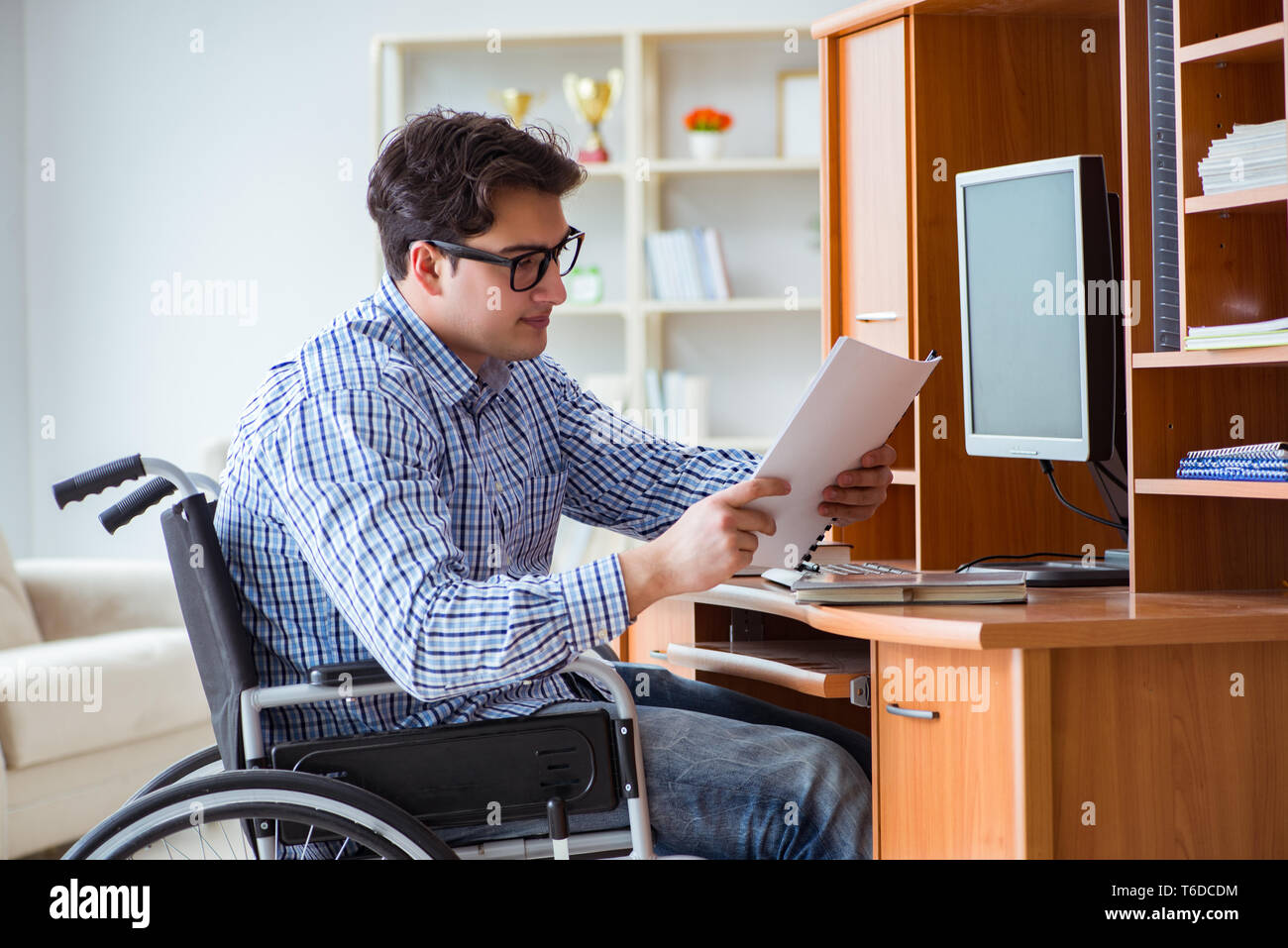 Disabled student studying at home on wheelchair Stock Photo - Alamy