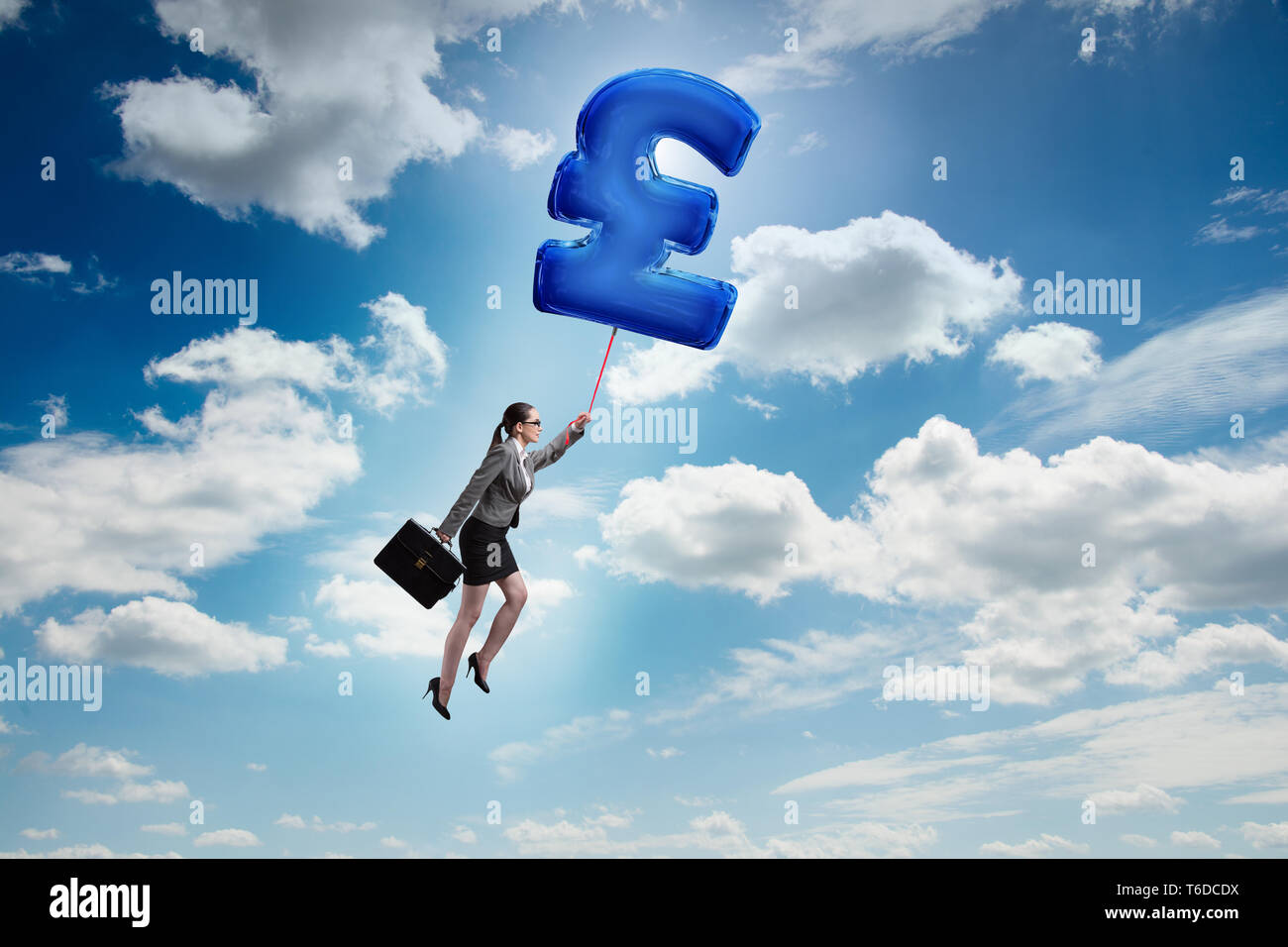 Businesswoman flying on british pound sign inflatable balloon Stock ...