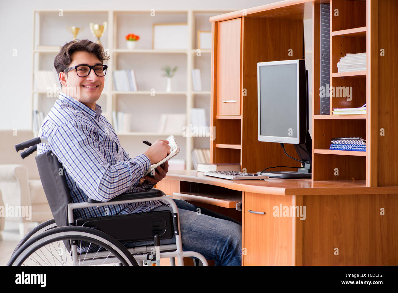 Disabled student studying at home on wheelchair Stock Photo - Alamy