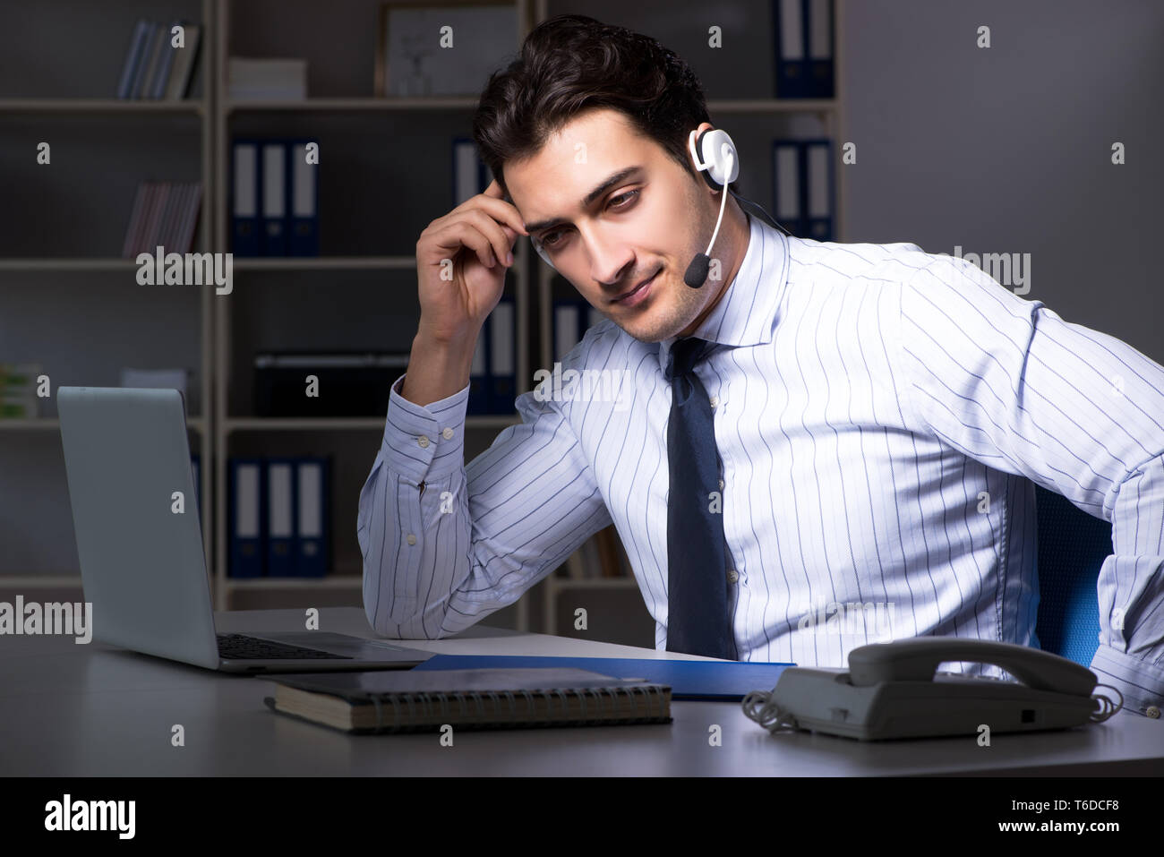 Tired and exhausted helpdesk operator during night shift Stock Photo ...