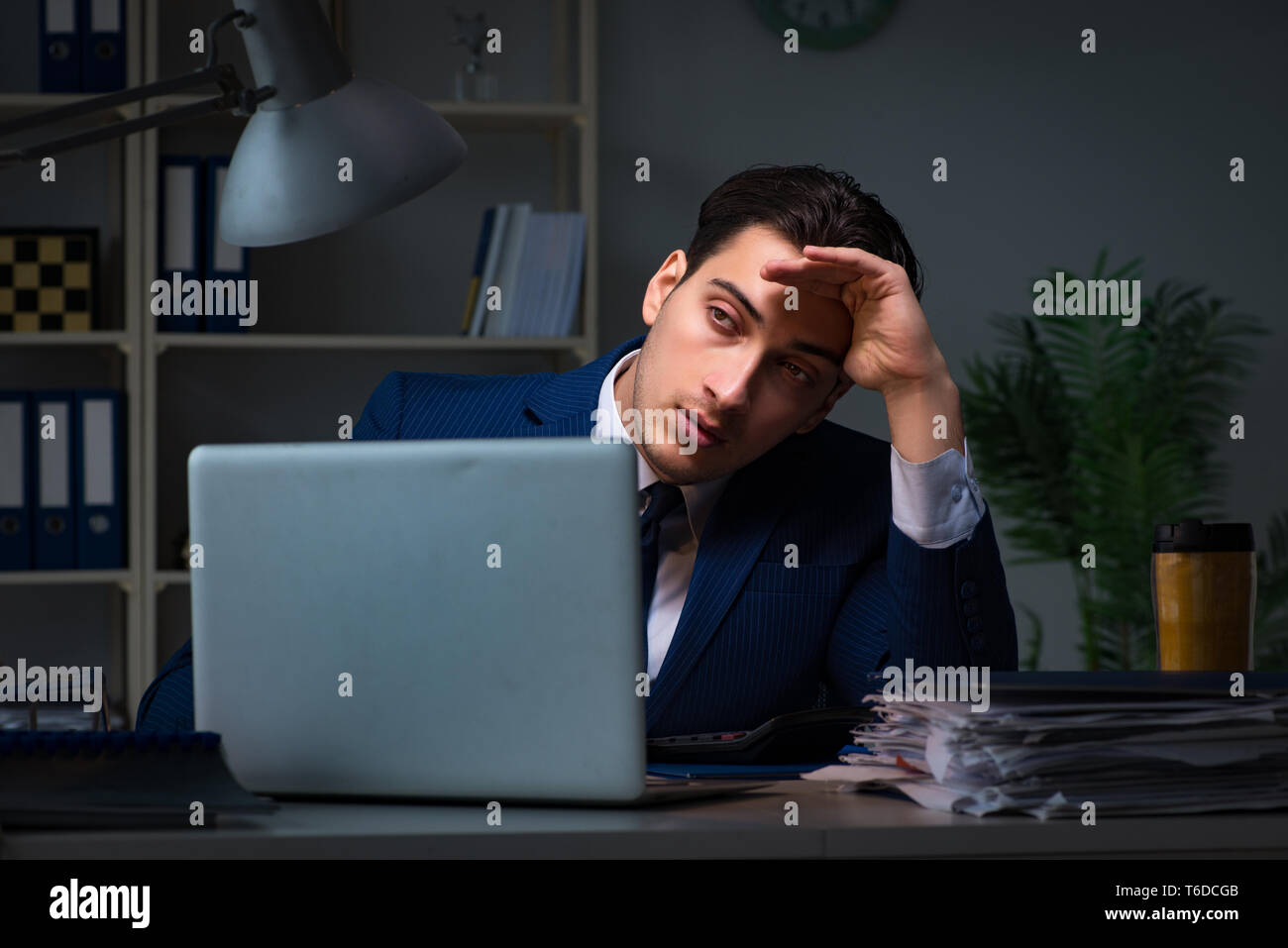 Employee working late to finish important deliverable task Stock Photo ...