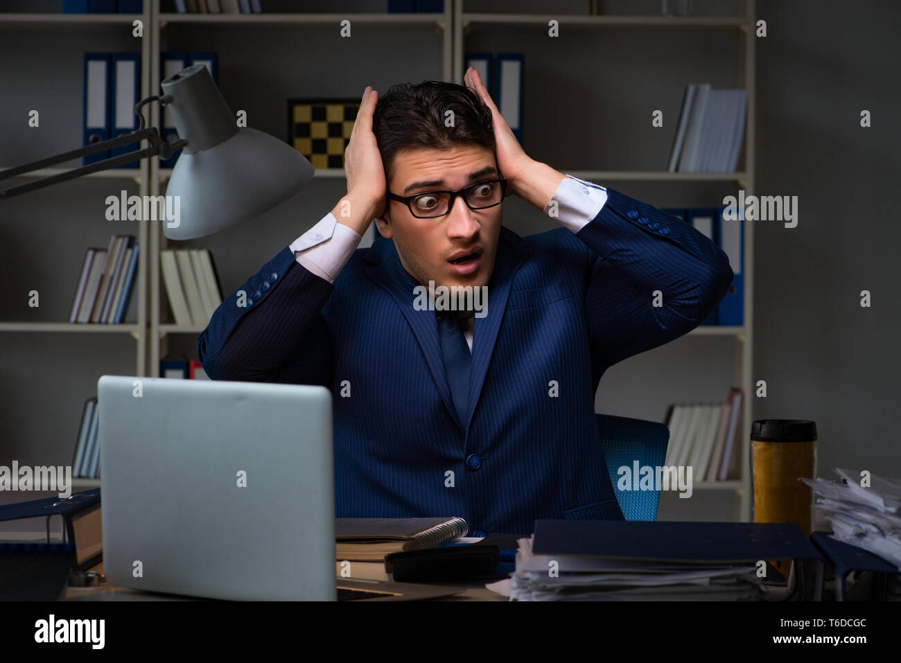 Employee working late to finish important deliverable task Stock Photo ...