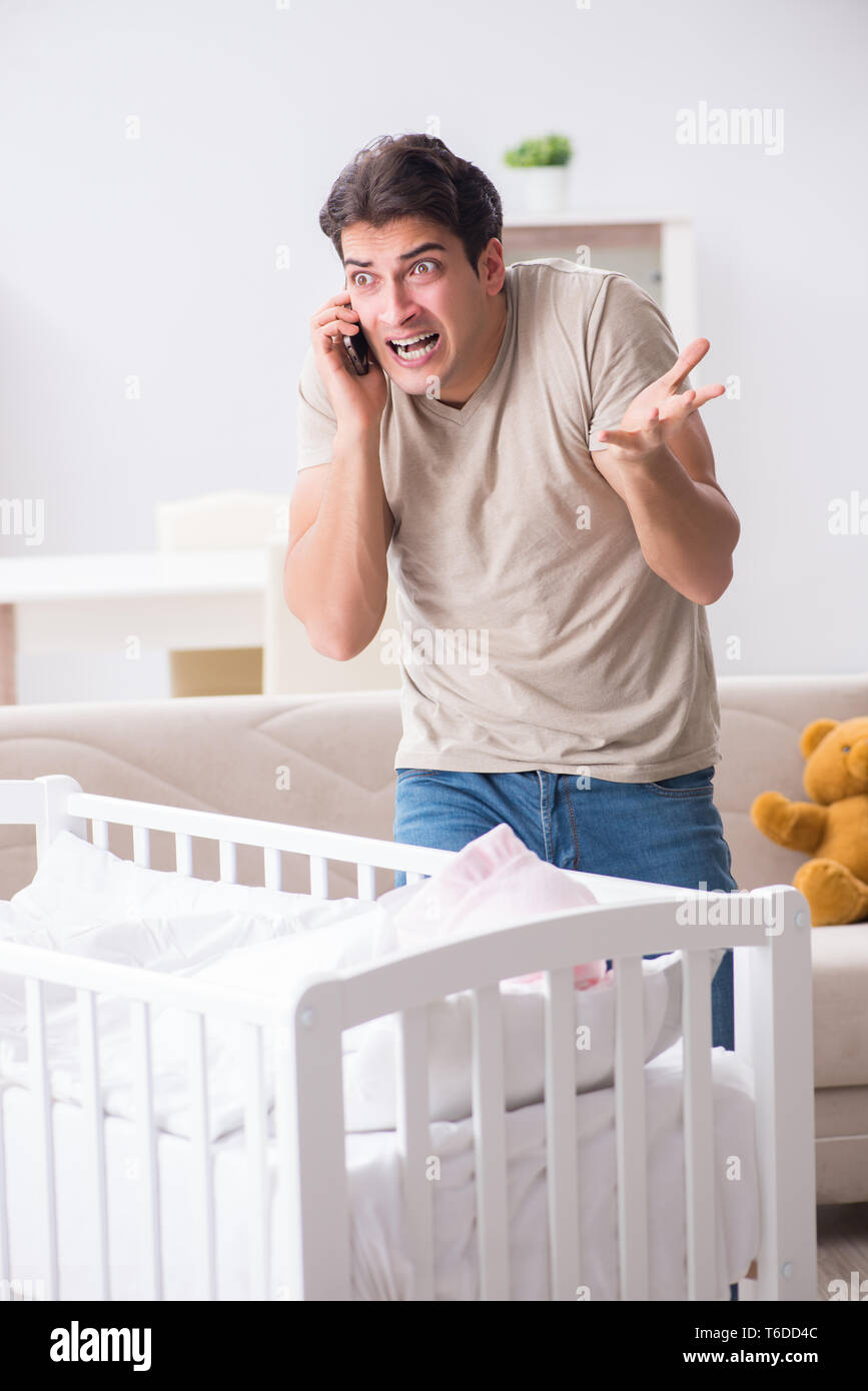 Young father dad frustrated at crying baby Stock Photo - Alamy
