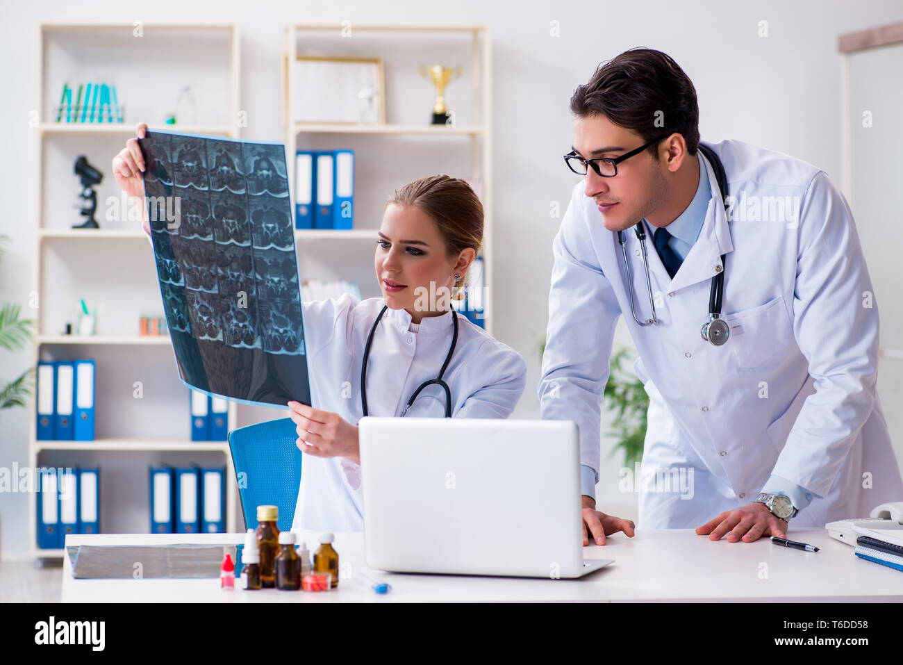 Two doctors examining x-ray images of patient for diagnosis Stock Photo ...