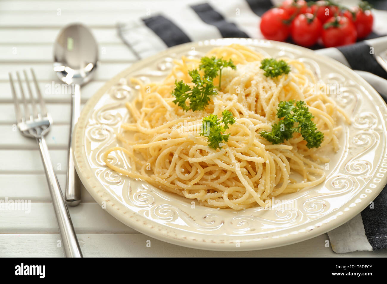 Plate with spaghetti and cheese on table. Delicious pasta recipes Stock ...