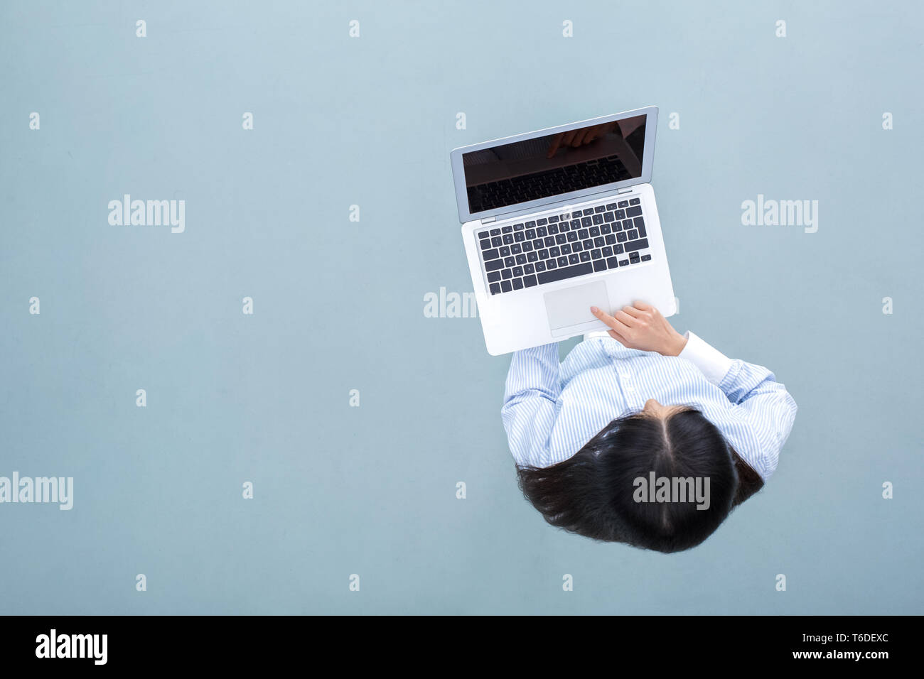 Young brunette woman standing top view isolated on grey background ...