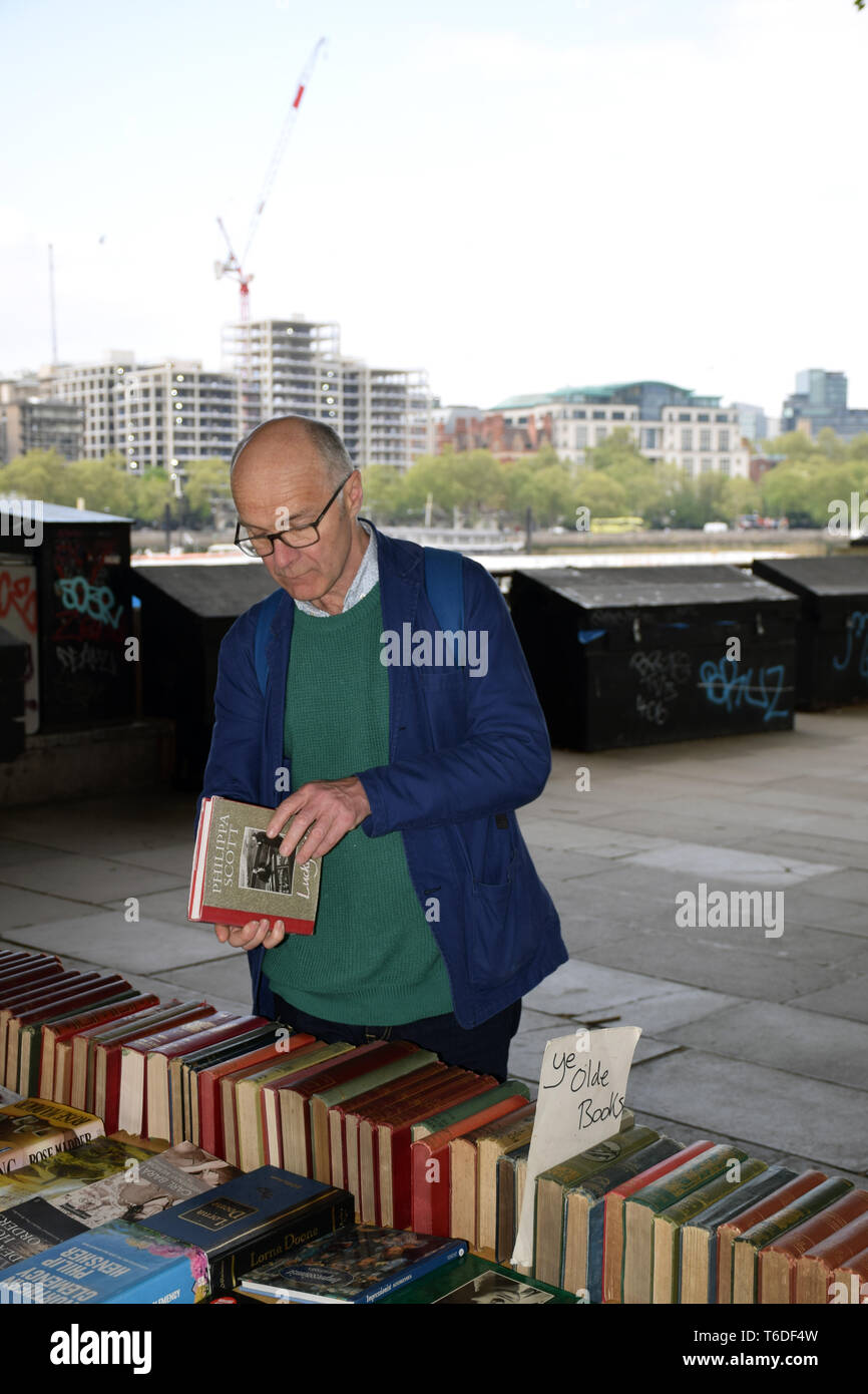 Second hand book stall on South Bank, London UK April 2019. Posed by ...