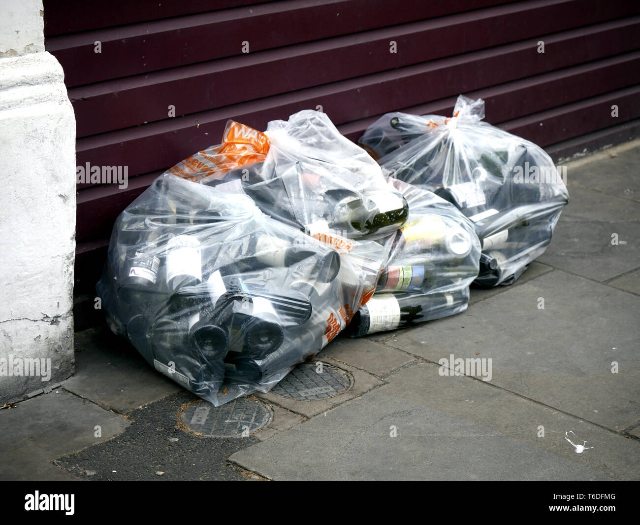 Wine bottles bagged up ready for recycling collection Stock Photo - Alamy