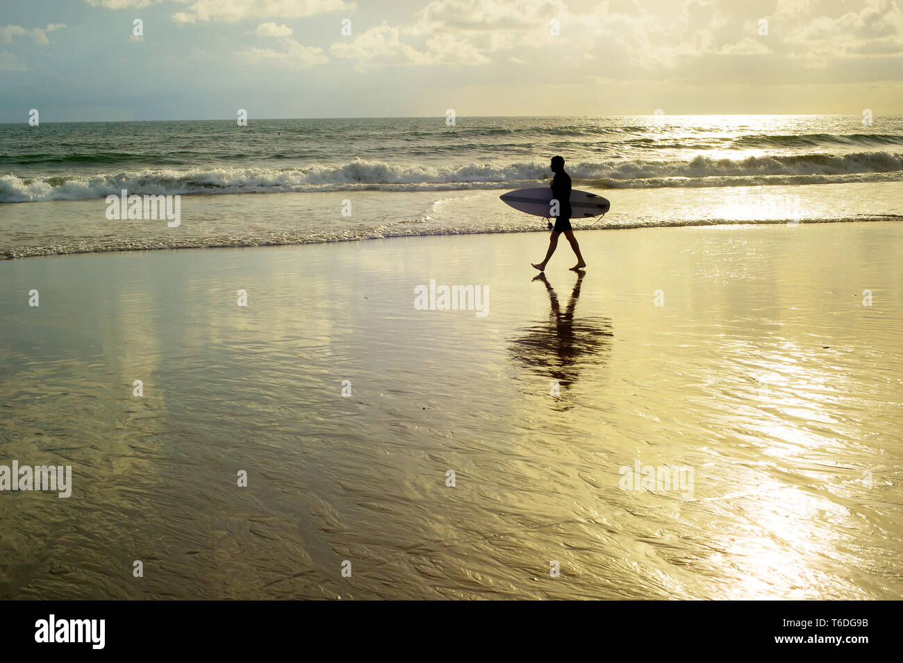Surfer walking on the beach Stock Photo - Alamy