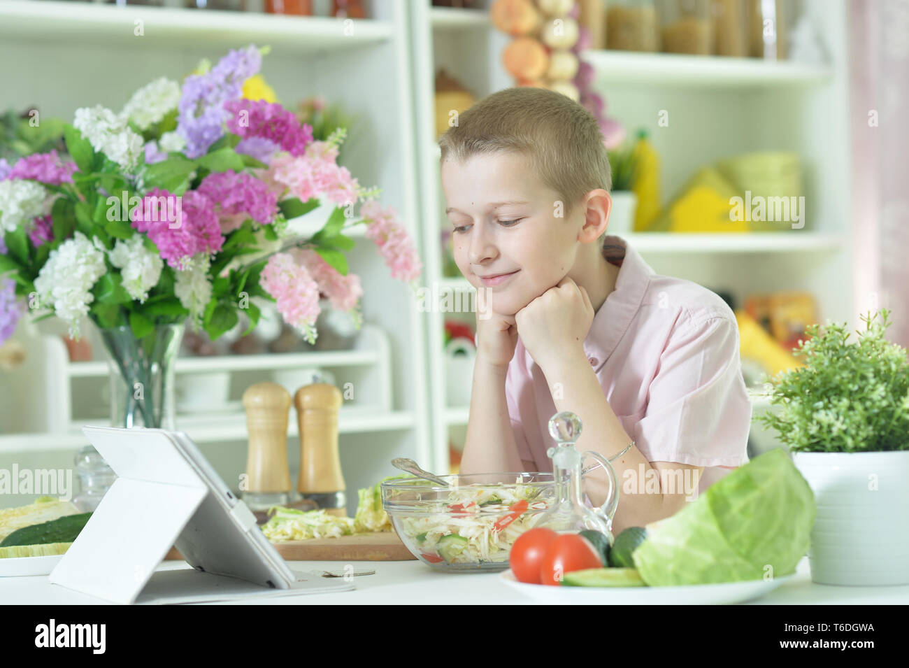 Portrait of cute little boy making dinner Stock Photo - Alamy