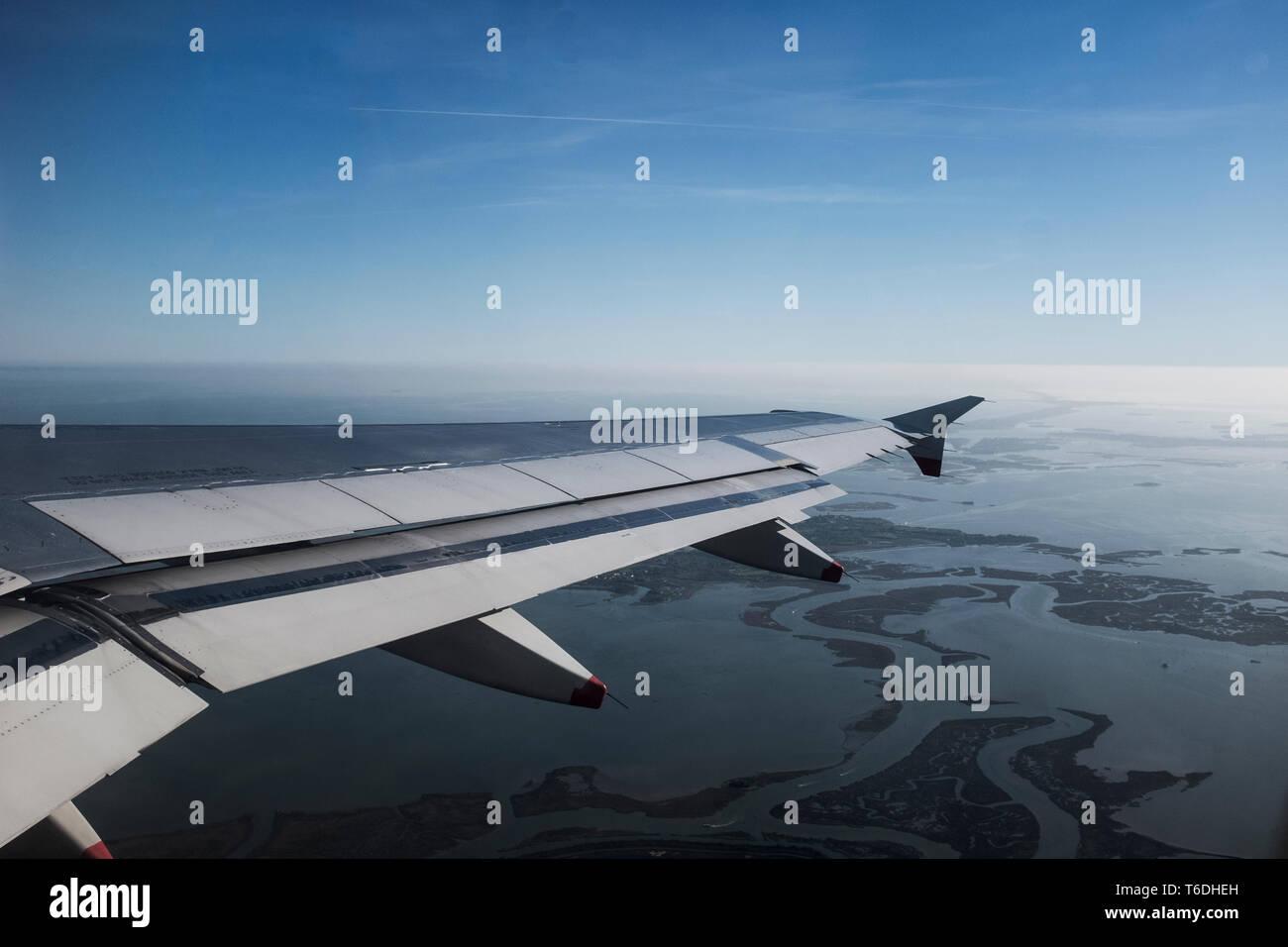 View across the Venice lagoon seen from a passenger plane window ...