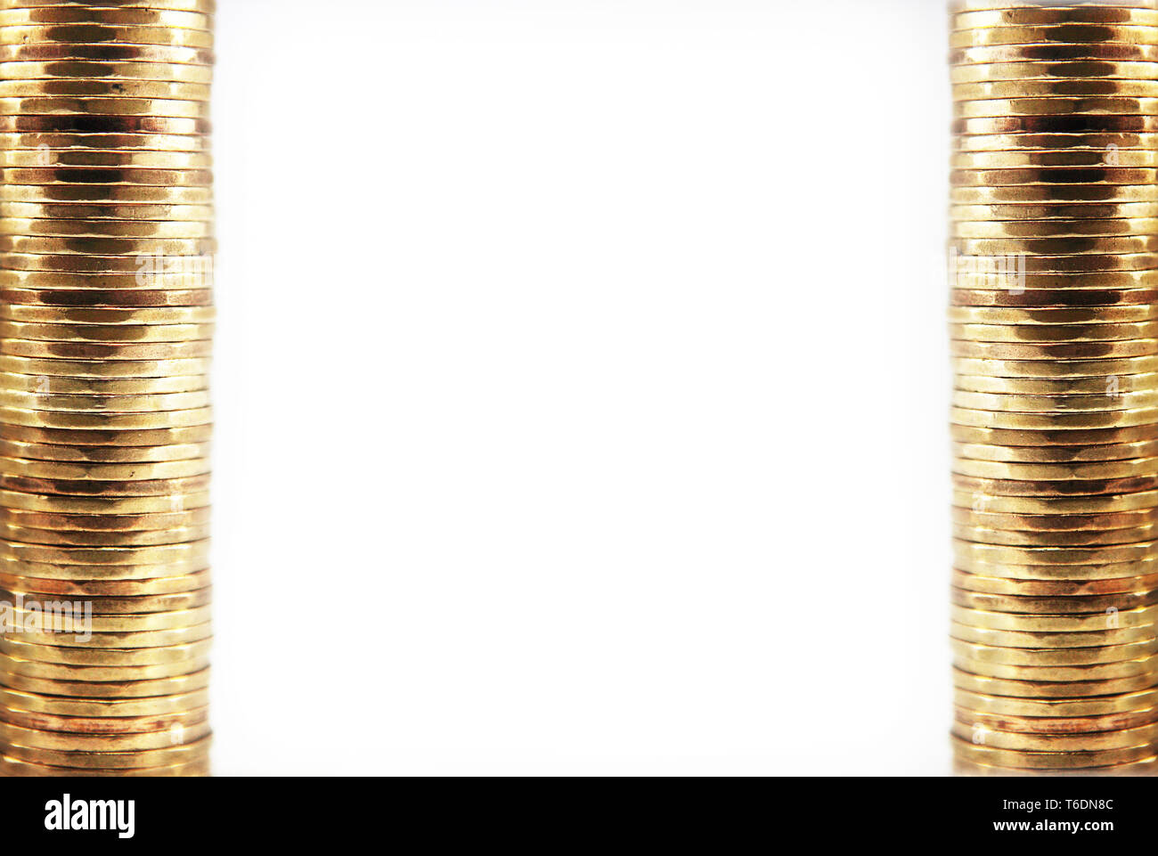 Two piles of (golden) coins placed vertically and symmetrical at the ...