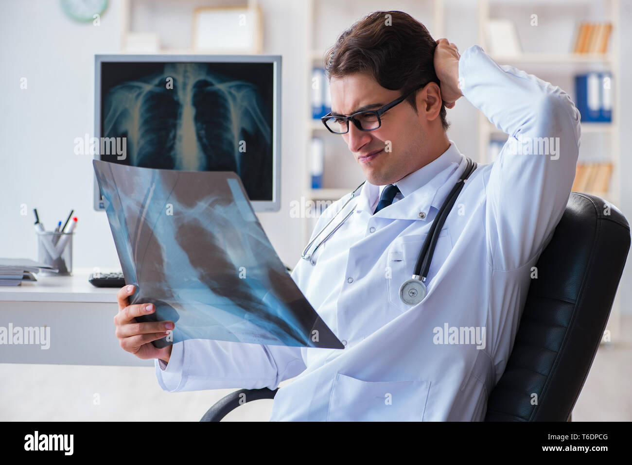 Doctor radiologist looking at x-ray images Stock Photo - Alamy