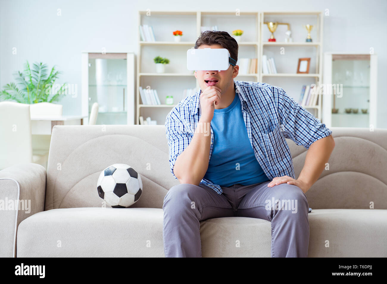 Man wearing virtual reality VR glasses watching soccer football Stock ...