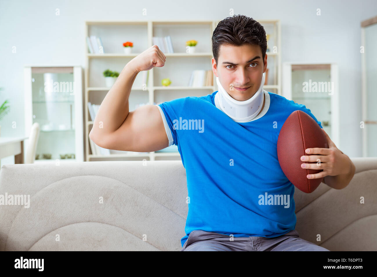 Man with neck injury watching american football at home Stock Photo - Alamy