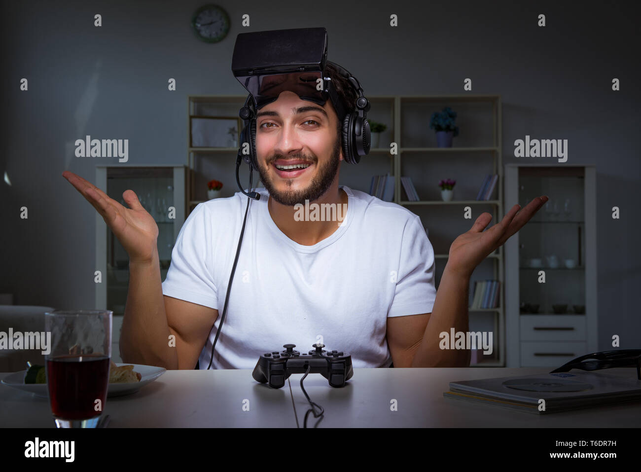 Young man playing games long hours late in the office Stock Photo - Alamy