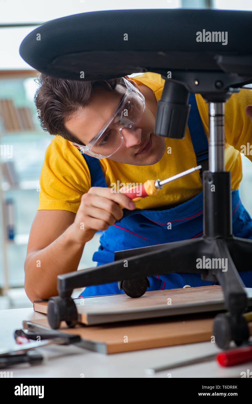 Furniture repairman working on repairing the chair Stock Photo - Alamy