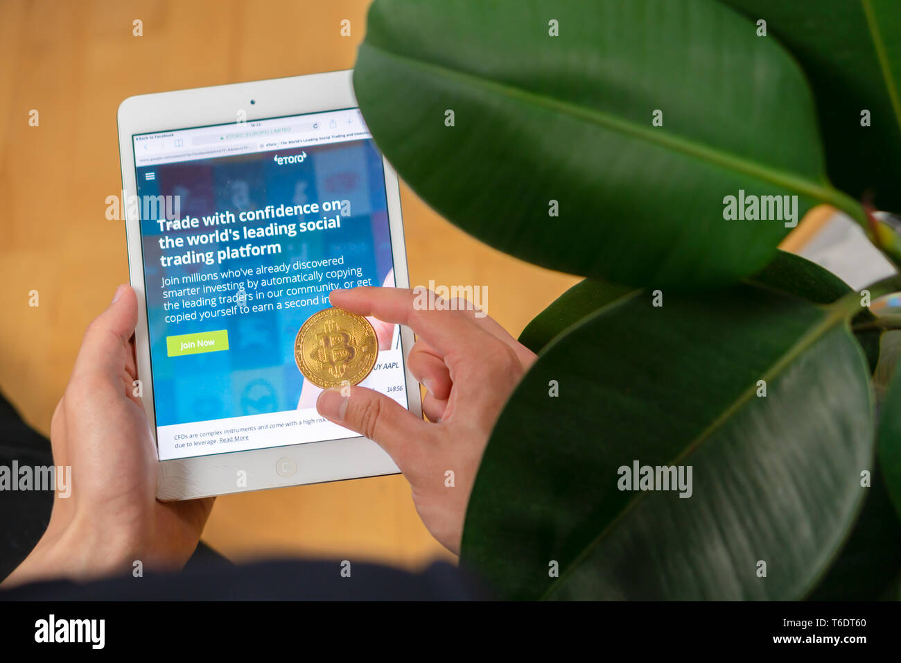 SLOVENIA - MARCH 29, 2019: eToro website on a tablet and businessman ...