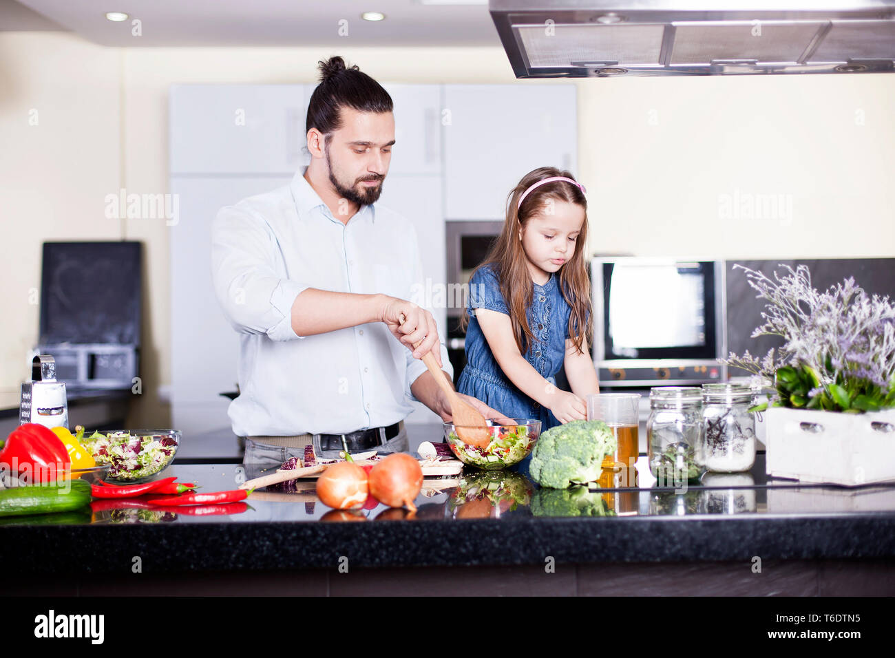 Father and daughter cooking meal together Stock Photo - Alamy