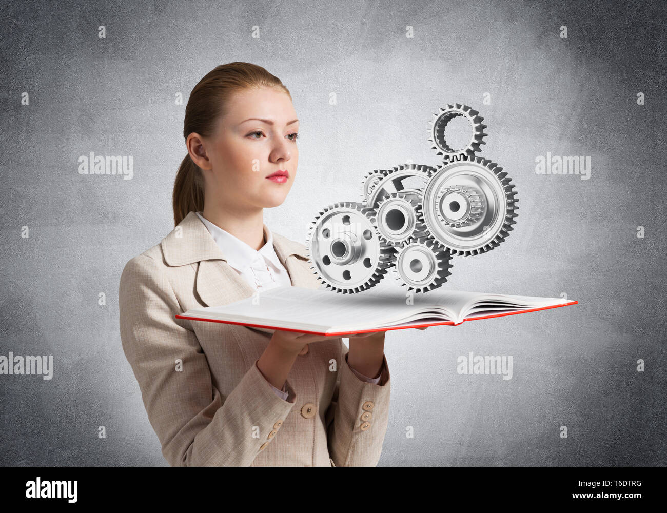 Woman showing abstract mechanism with cogwheels Stock Photo - Alamy