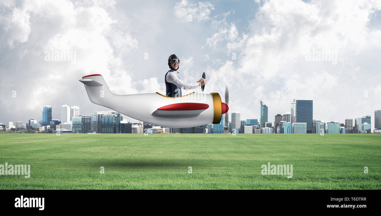 Happy aviator driving small propeller plane Stock Photo - Alamy