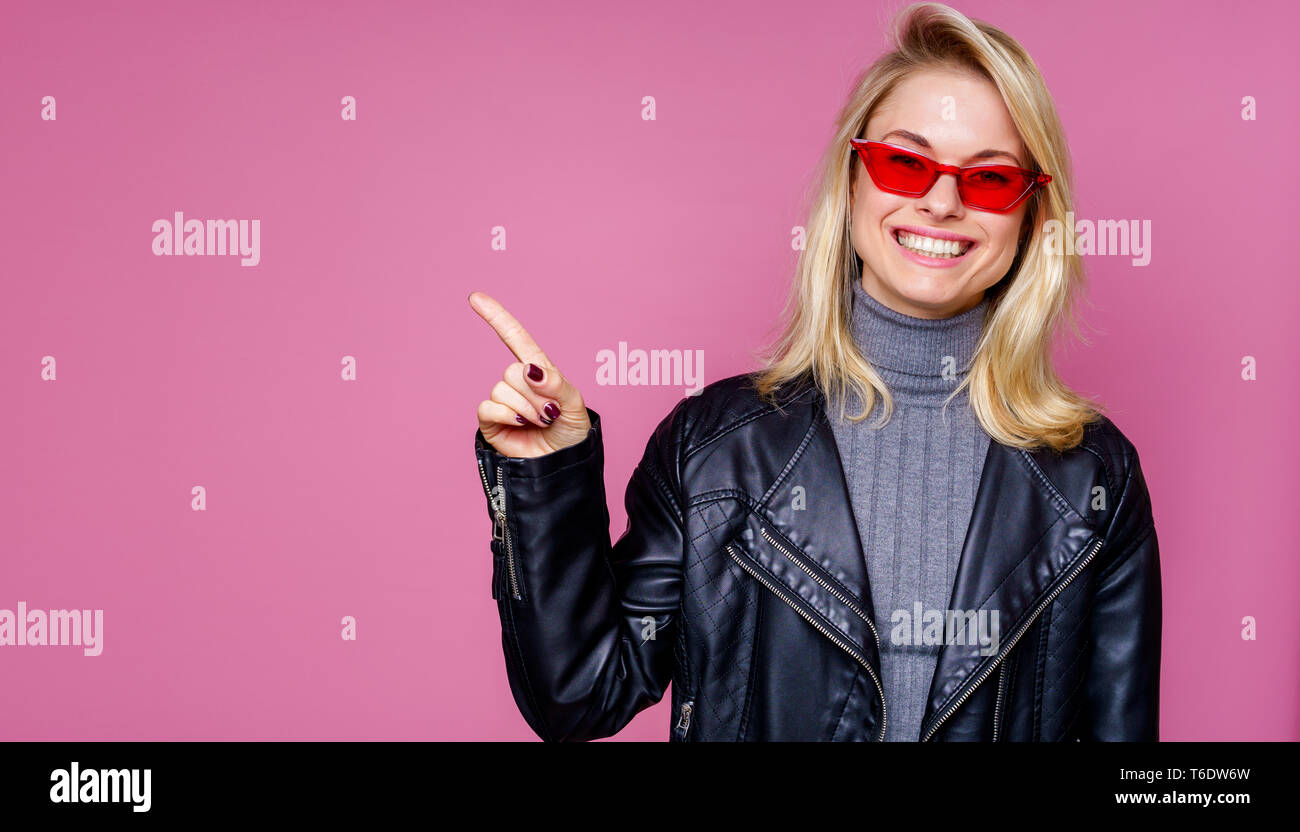 Image of blonde in pink glasses and leather jacket pointing finger to ...