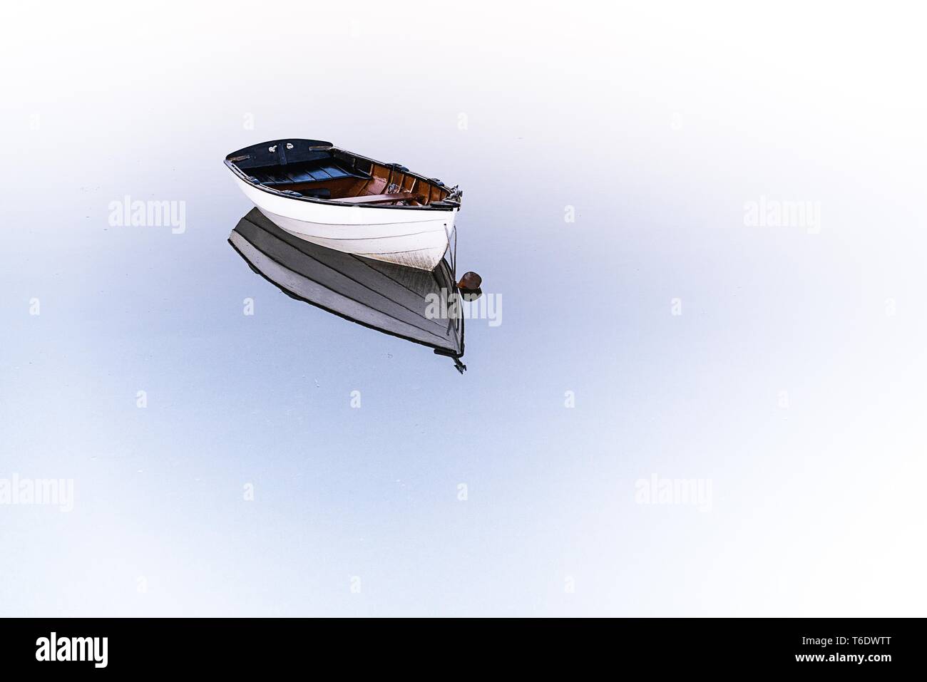 A little rowboat with reflection in the water Stock Photo - Alamy