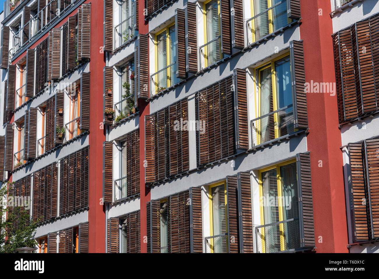 Facade of a modern apartment house with wooden windows shutters seen in ...