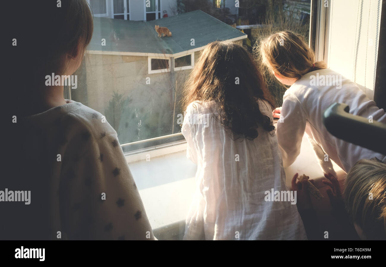 Girls watching out the window Stock Photo - Alamy