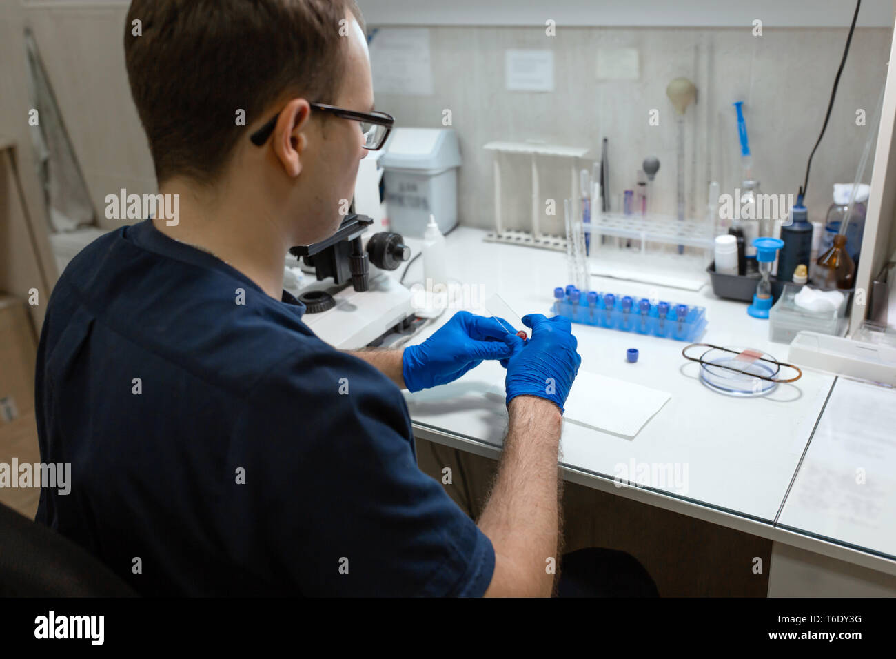 scientist prepare blood sample for research on microscope. Placing ...
