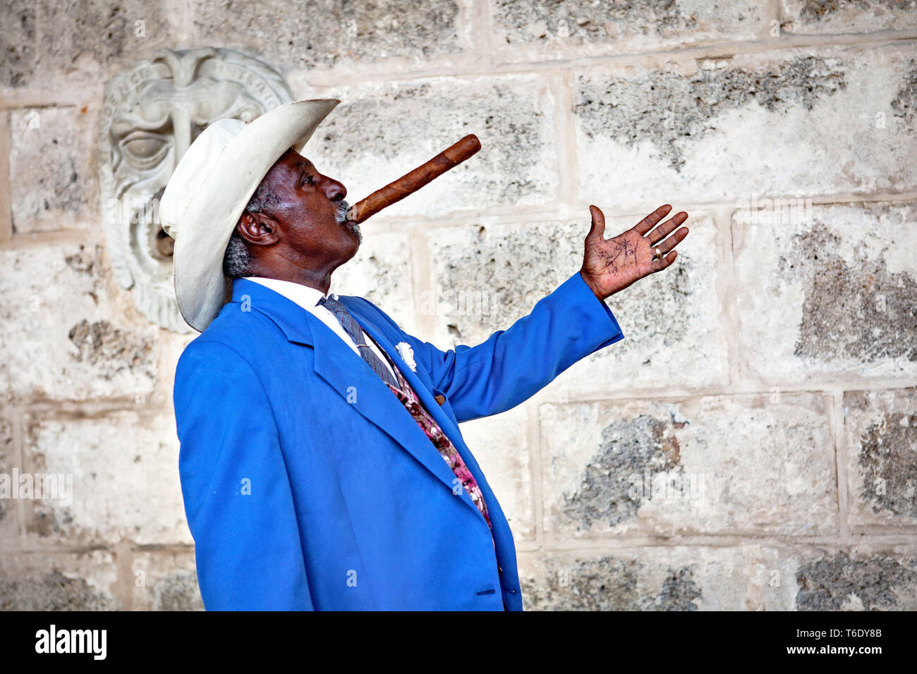 Traditional Cuban man posing for photos while smoking big cuban cigar ...