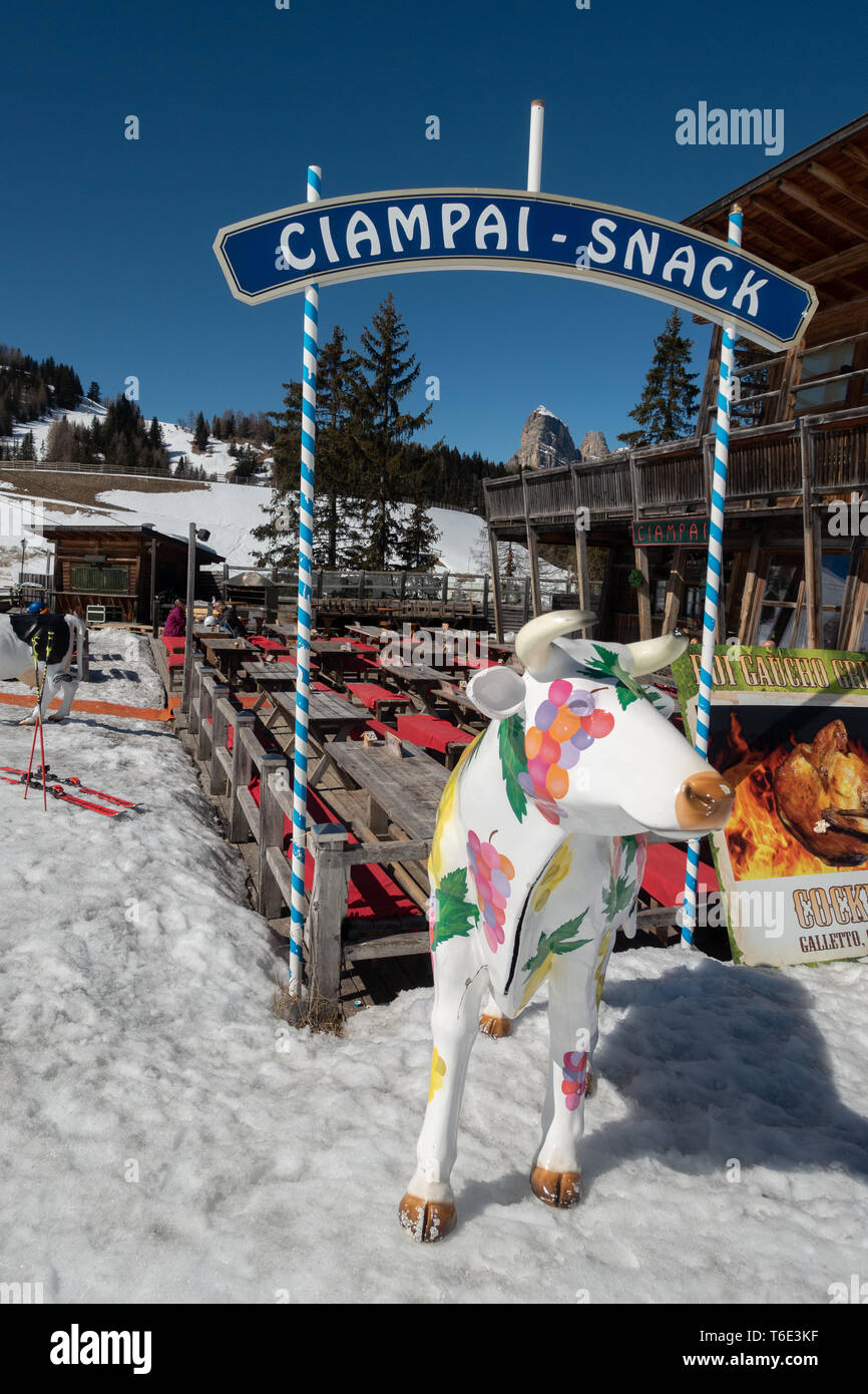 A decorative model cow stands at the entrance of a mountain restaurant ...