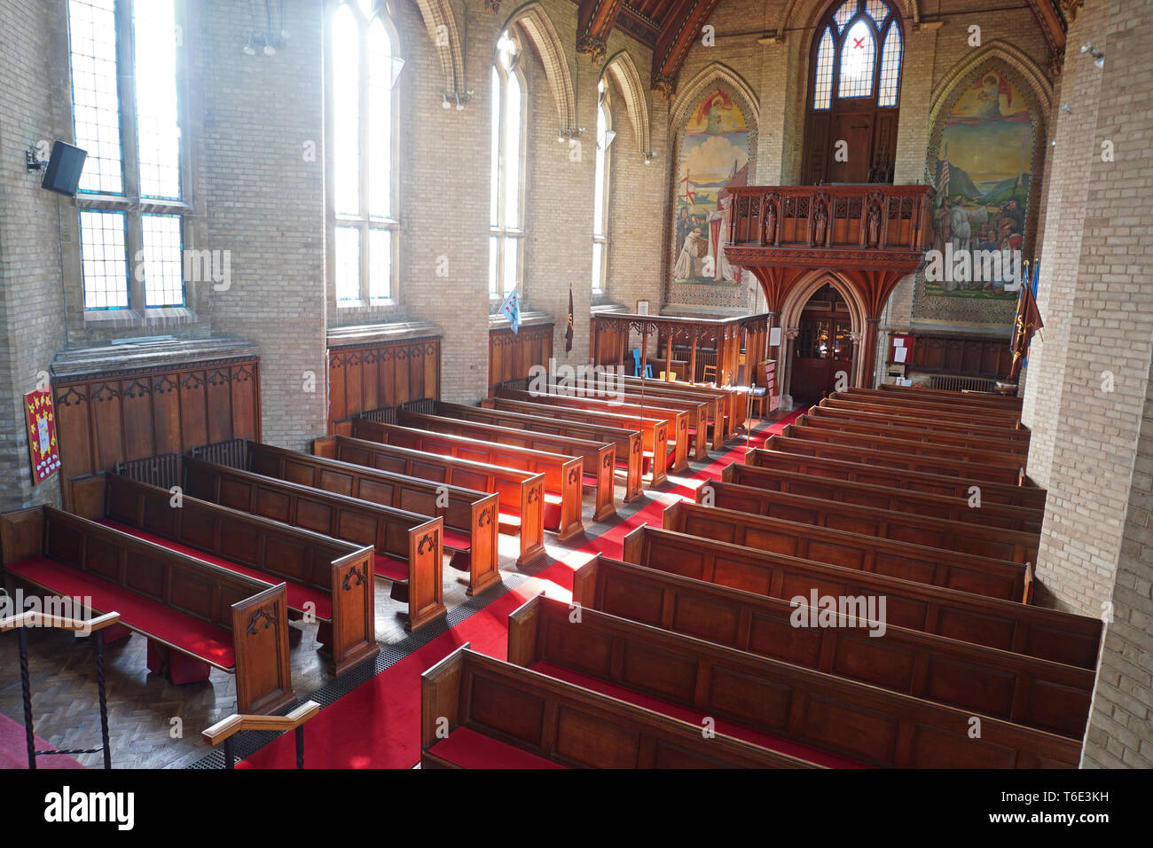 A view of the interior of a parish curch in the UK with empty pews ...