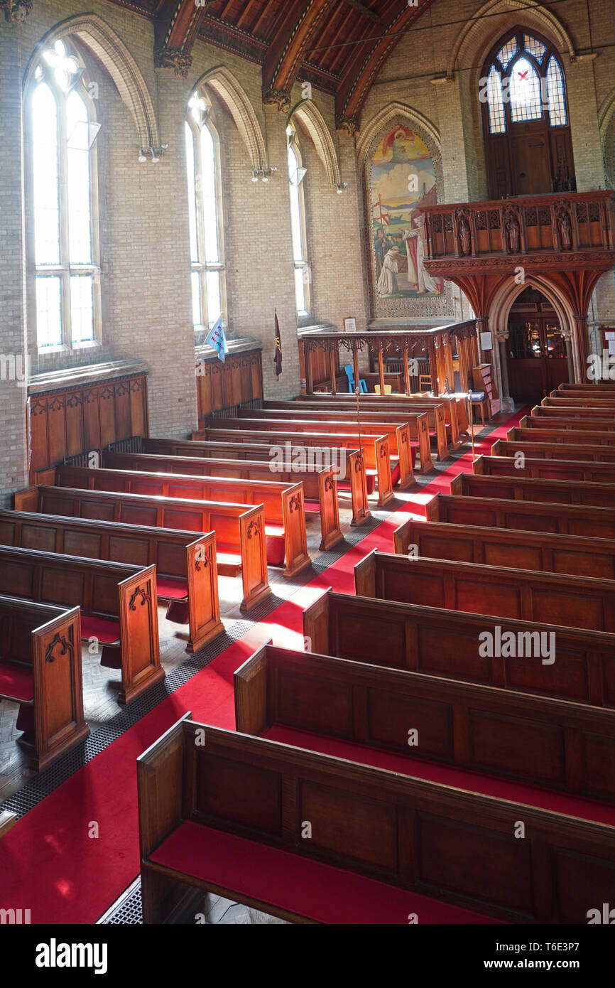 A view of the interior of a parish curch in the UK with empty pews ...