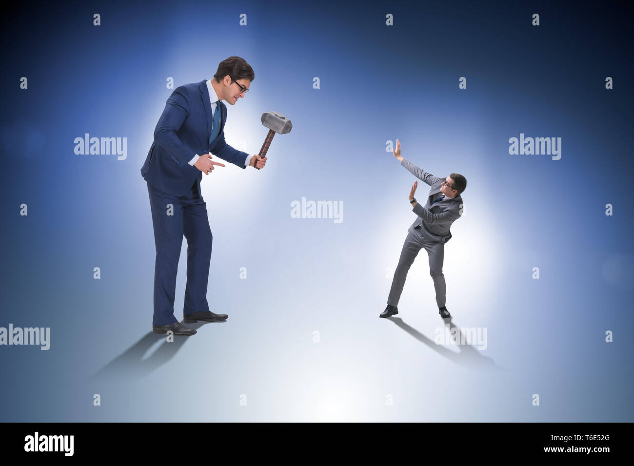 Bad angry boss threatening employee with hammer Stock Photo - Alamy