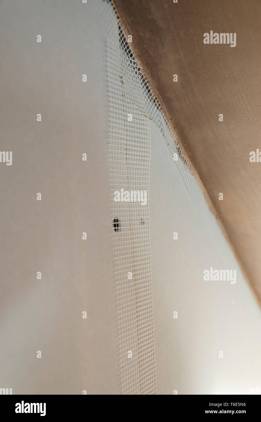 Plastering new plasterboard with jointing tape detail shown Stock Photo ...