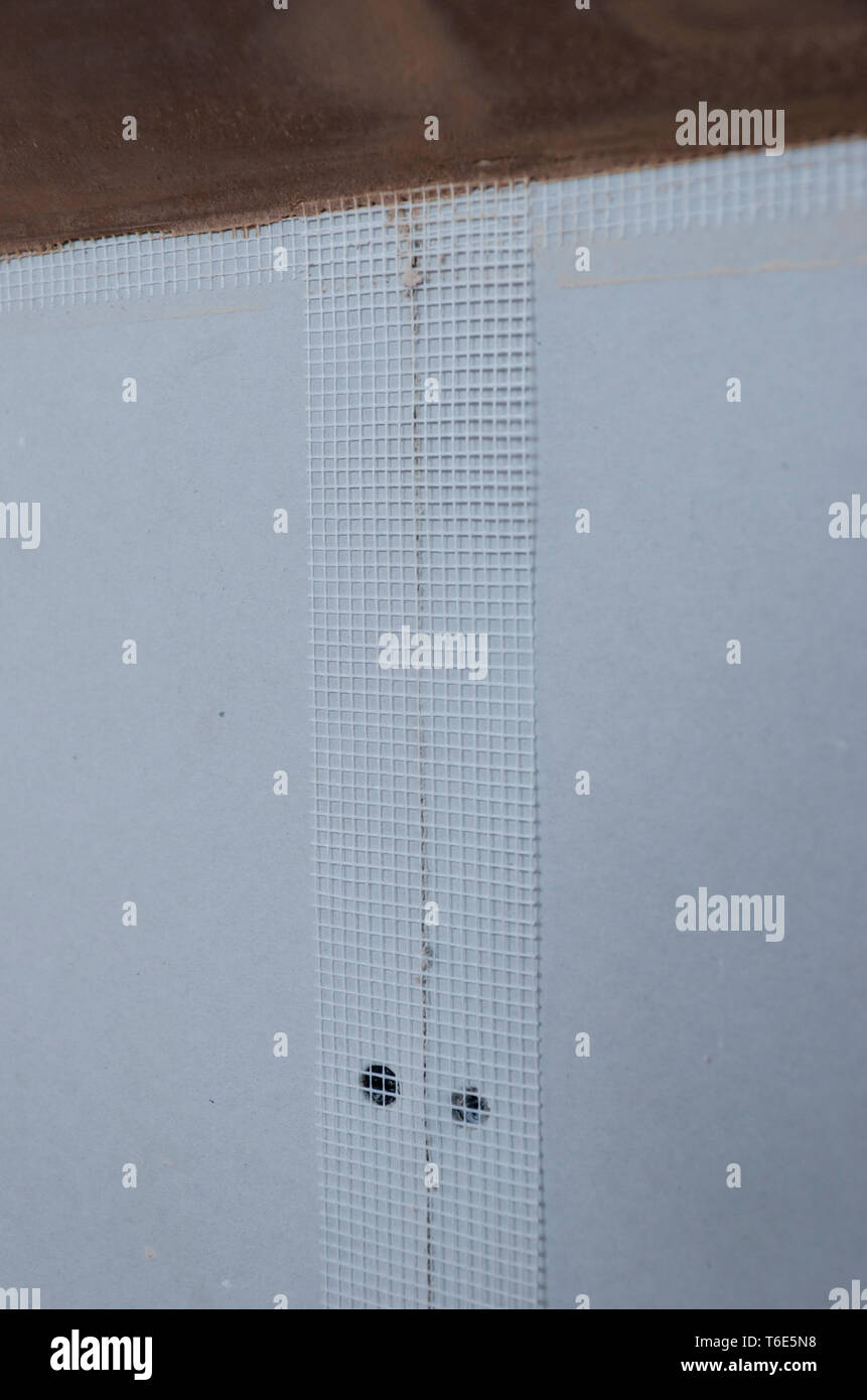 Plastering new plasterboard with jointing tape detail shown Stock Photo ...